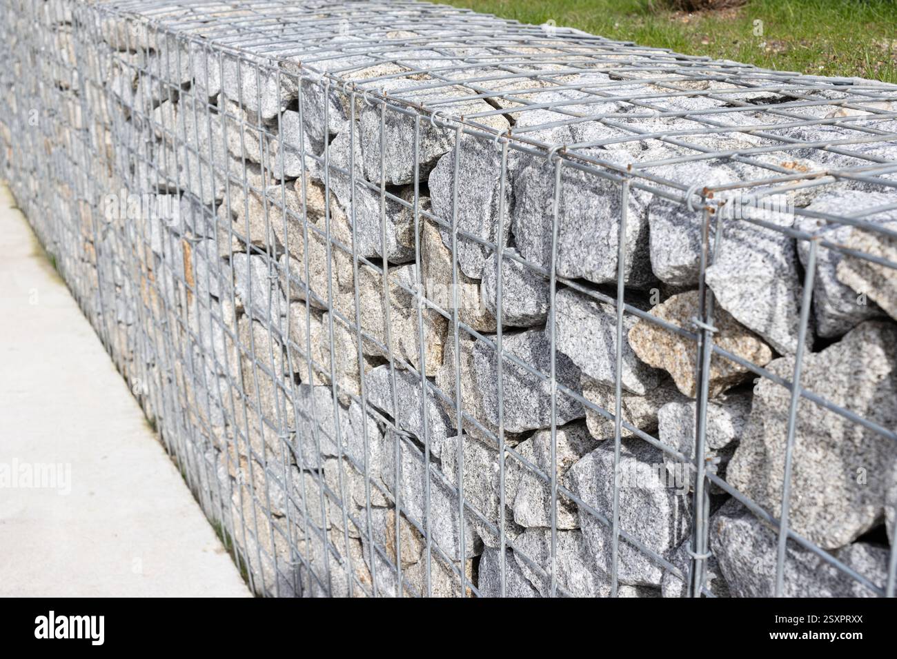 Detail of a gabion wall made of granite stones and wire mesh used for ...