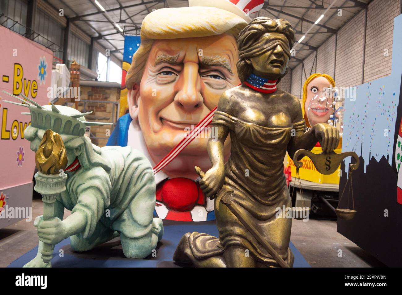 A carnival float features US President Donald Trump holding a leash on ...
