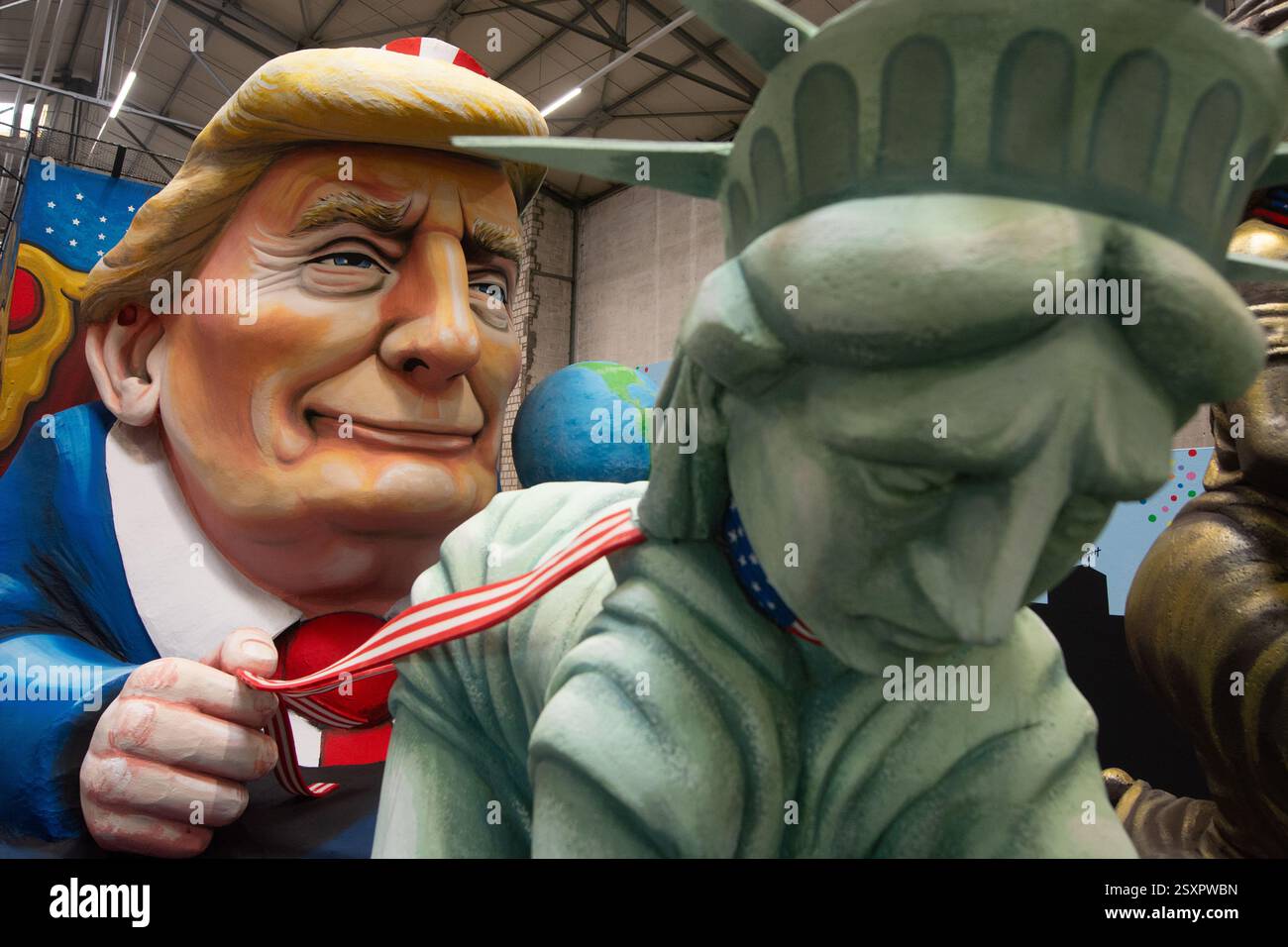 A carnival float features US President Donald Trump holding a leash on ...