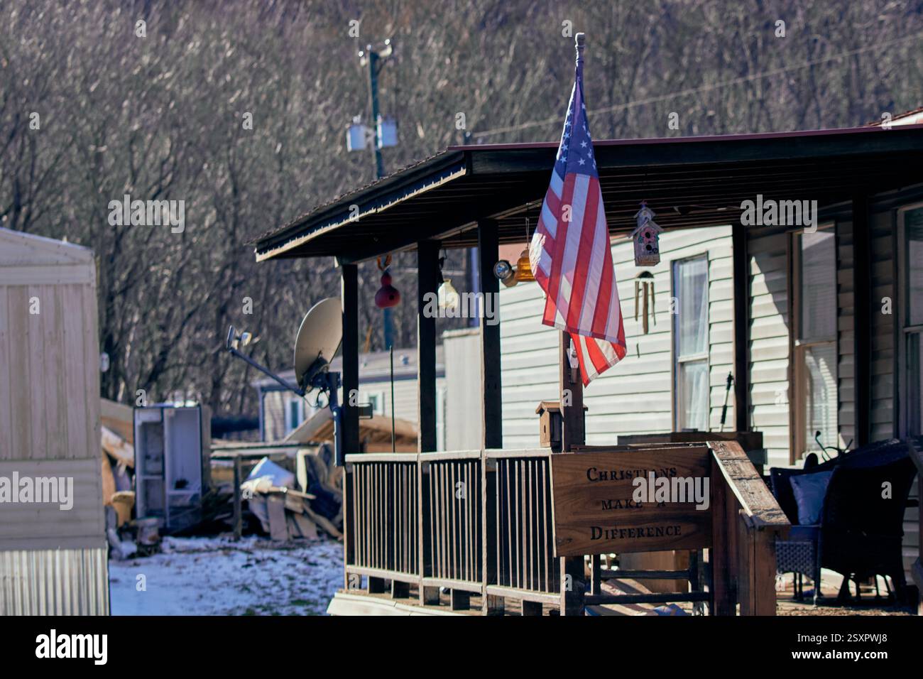 An American flag stands on a house abandoned after being inundated by ...
