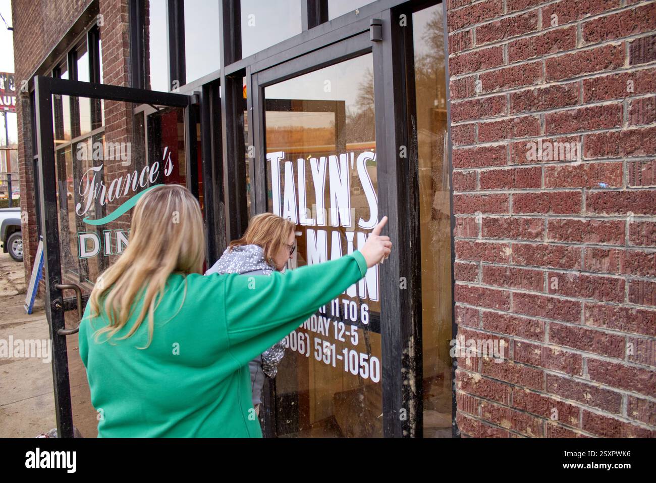 Shop owners inspect damage to their businesses along Main Street in ...