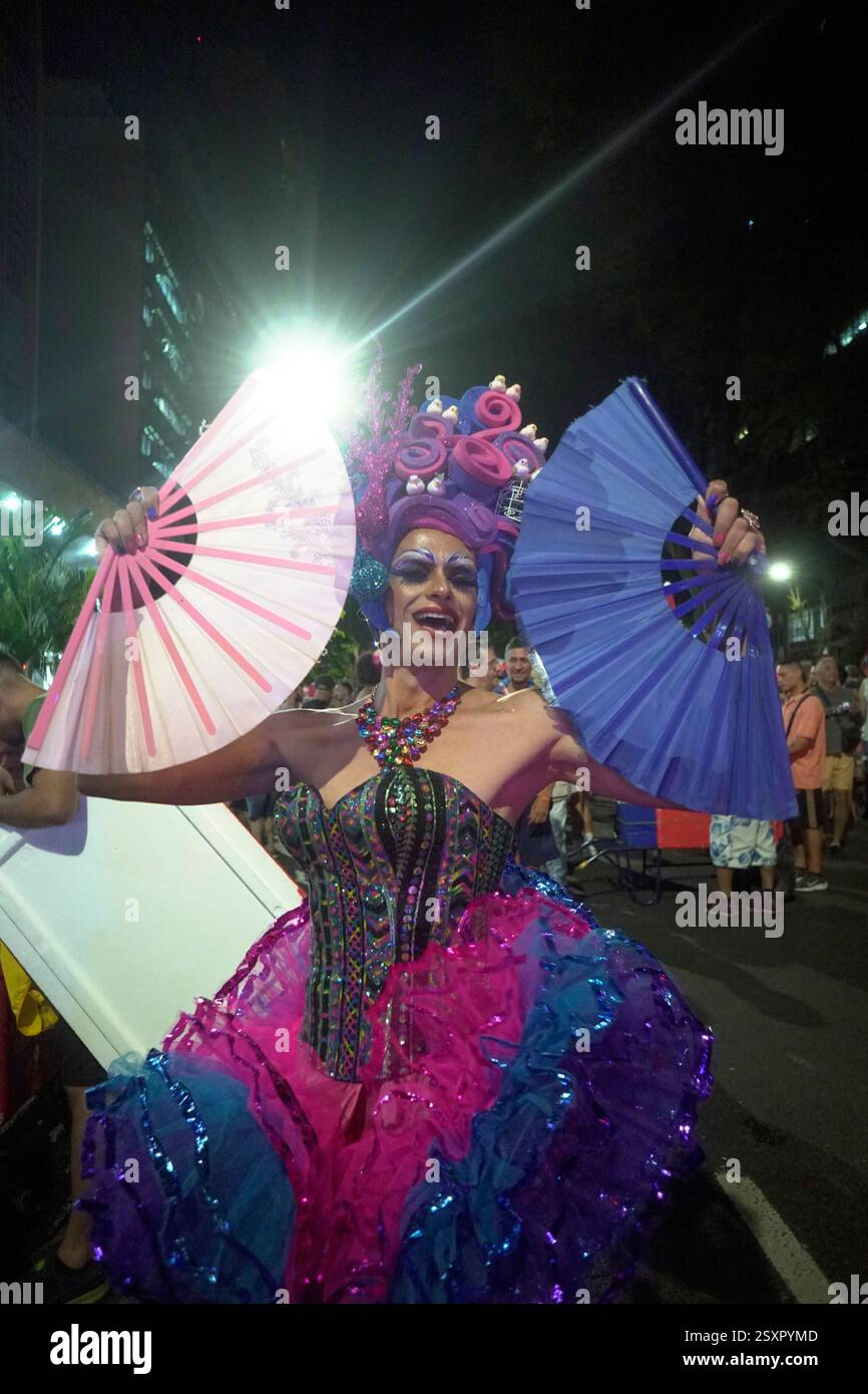 Revelers have fun at the pre-carnival street party in Sao Paulo, Brazil ...