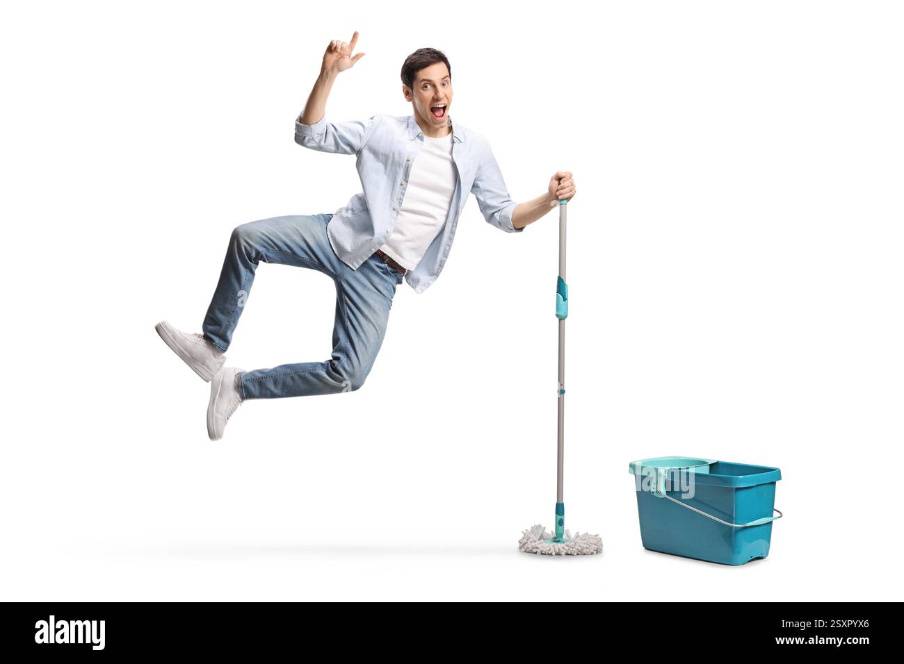 Young man jumping with a cleaning mop and a bucket isolated on white ...