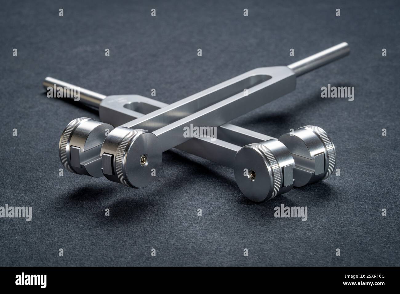 Weighted and unweighted metal tuning forks used for tuning musical ...