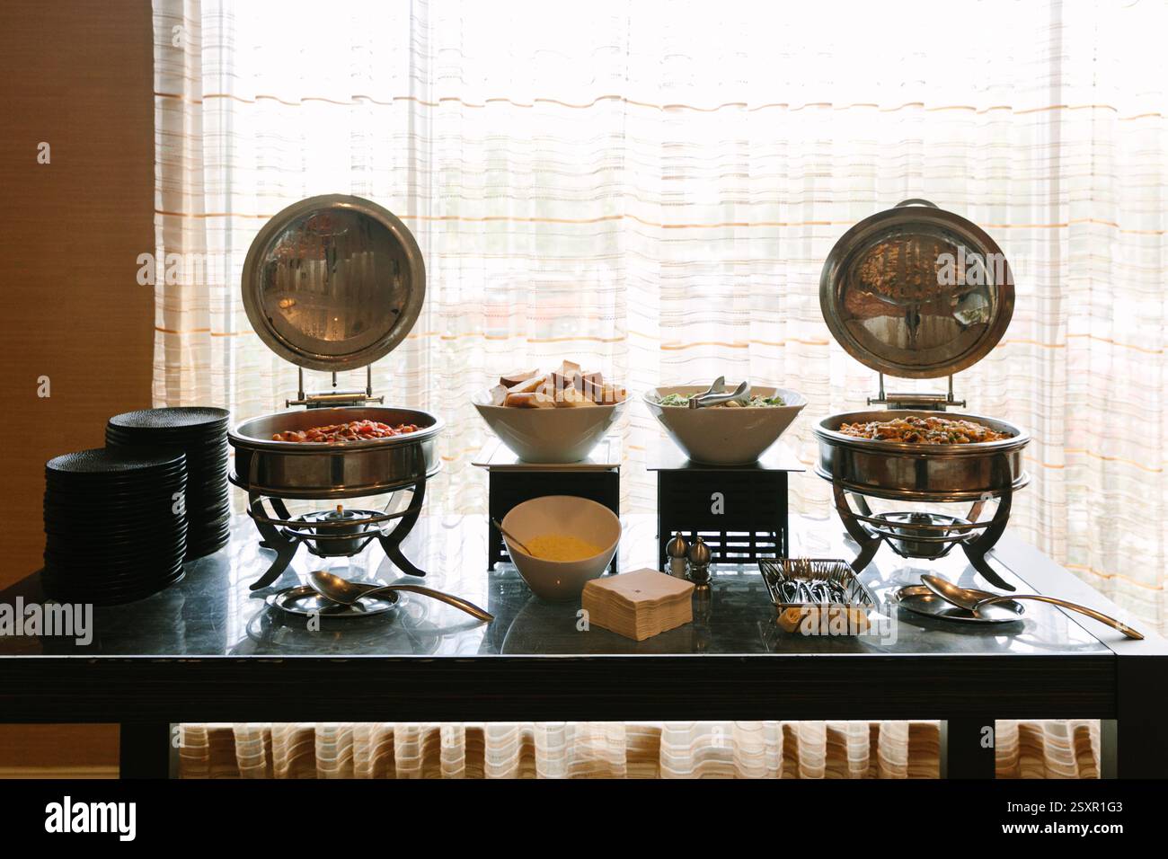 Buffet setup featuring various dishes in a well-lit dining area during ...