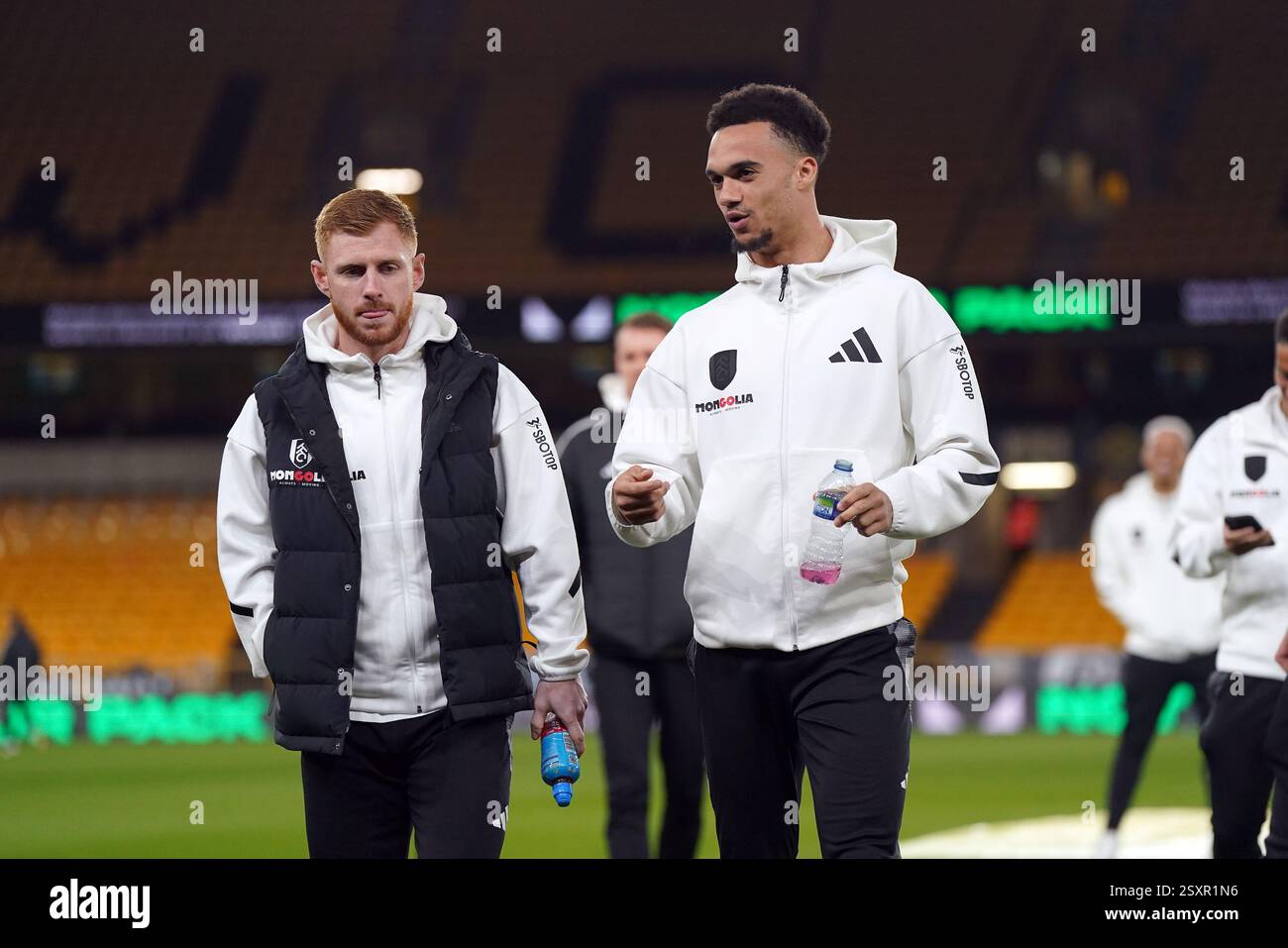 Fulham's Harrison Reed and Antonee Robinson (right) inspect the pitch ...