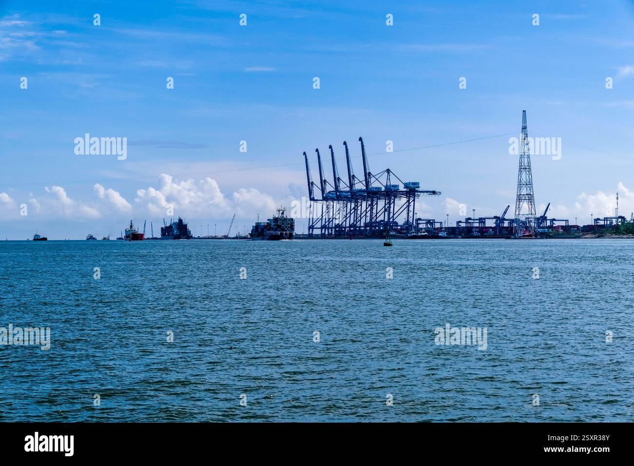 Crane systems and cargo ships in the harbour of Cat Hai. Cat Ba Hai ...