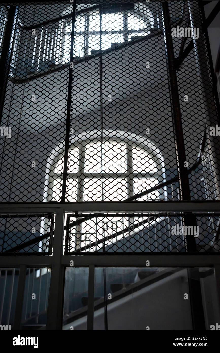 Interior staircase shaft and elevator cables in an old apartment ...