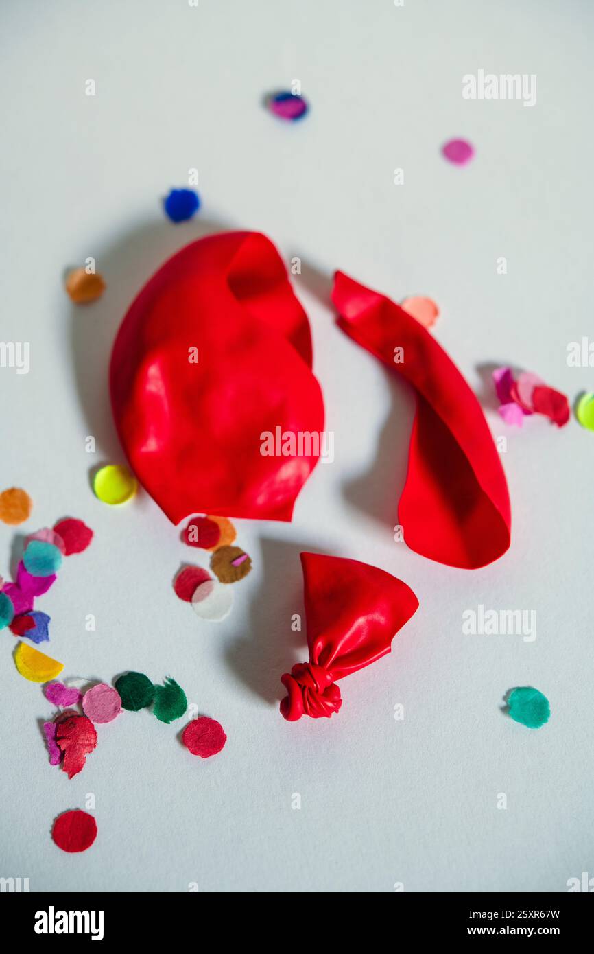 Still life of a burst red balloon Stock Photo - Alamy