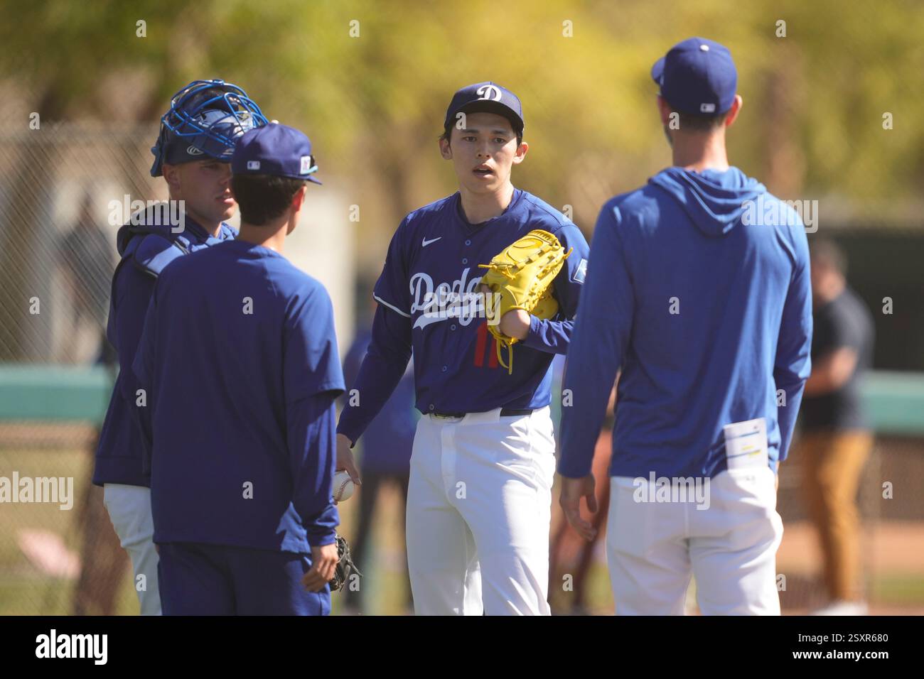 Los Angeles Dodgers pitcher Roki Sasaki, center right, stands with ...