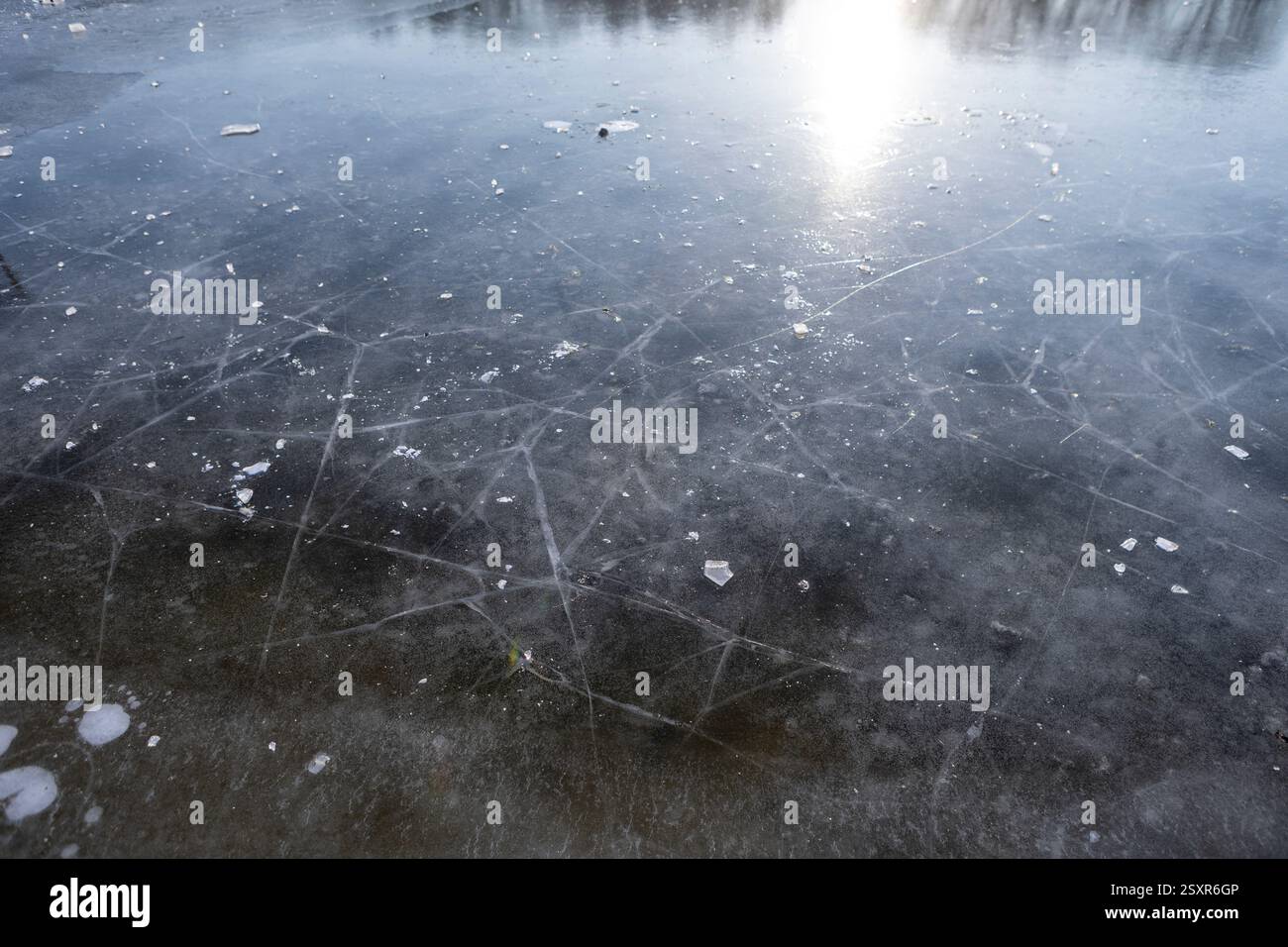 Walking on ice covering a frozen winter river. Cracks, air bubbles and ...