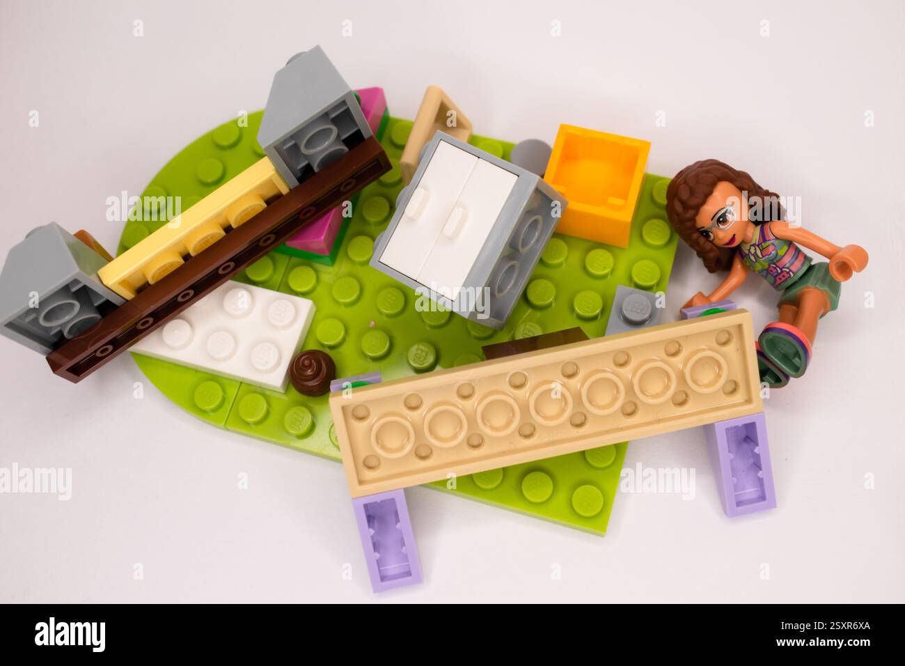 Abstract image of lego bricks and mini-doll figure isolated on a white ...