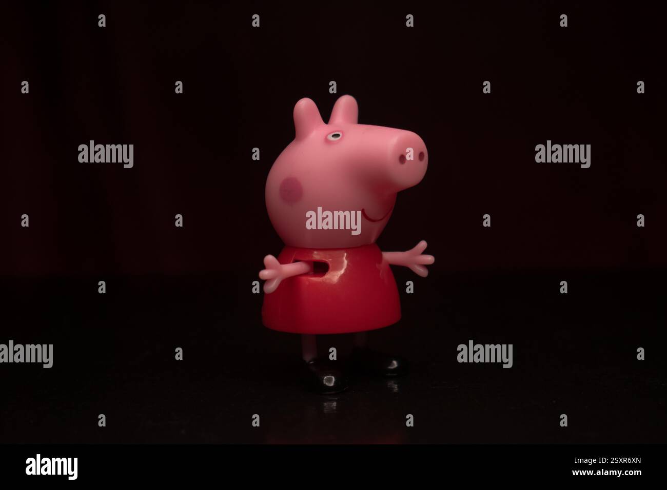 Happy Peppa Pig figurine on a black background with copy space Stock ...