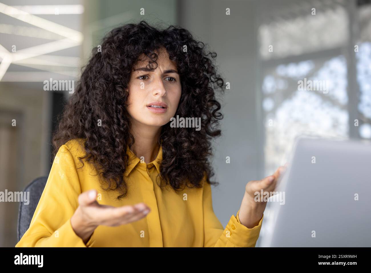 Serious and anxious woman talking to colleagues and partners sitting at ...