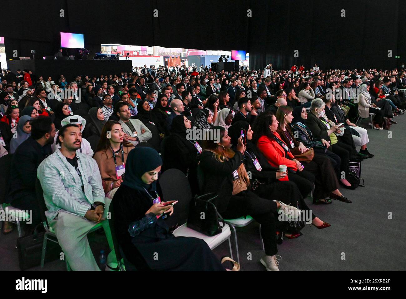 WEB SUMMIT QATAR 2025 - DAY THREE Attendees listening to the Badr ...