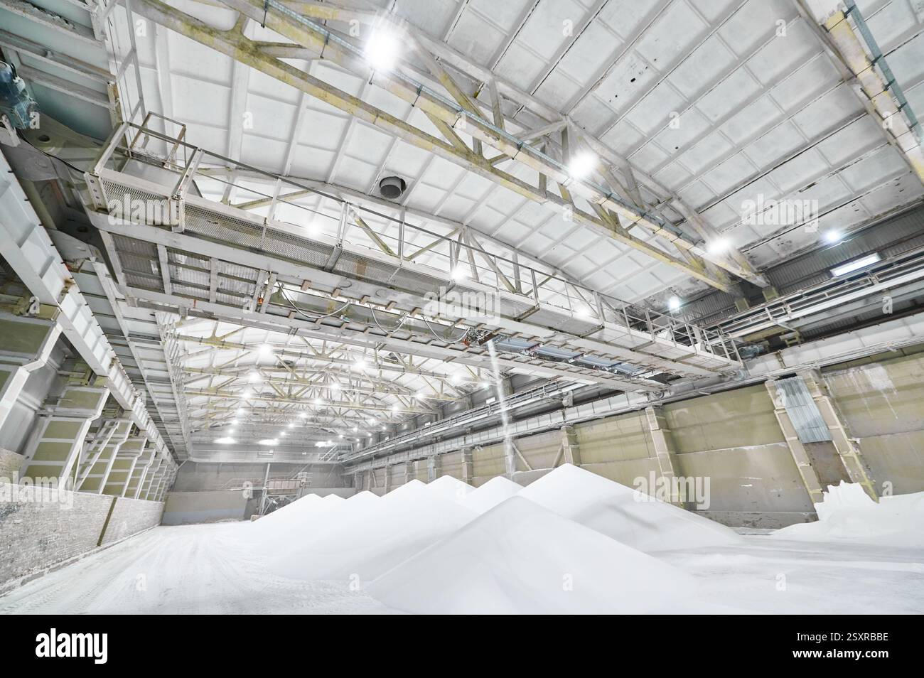 Inside a modern chemical plant warehouse with conveyor systems moving ...