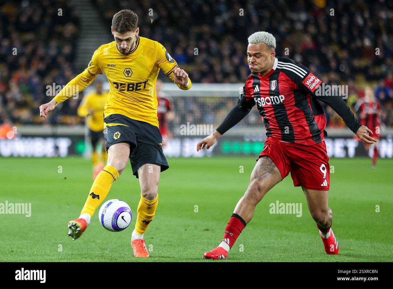 #4, Santiago Bueno of Wolves attempts to get his toe to the ball ahead ...