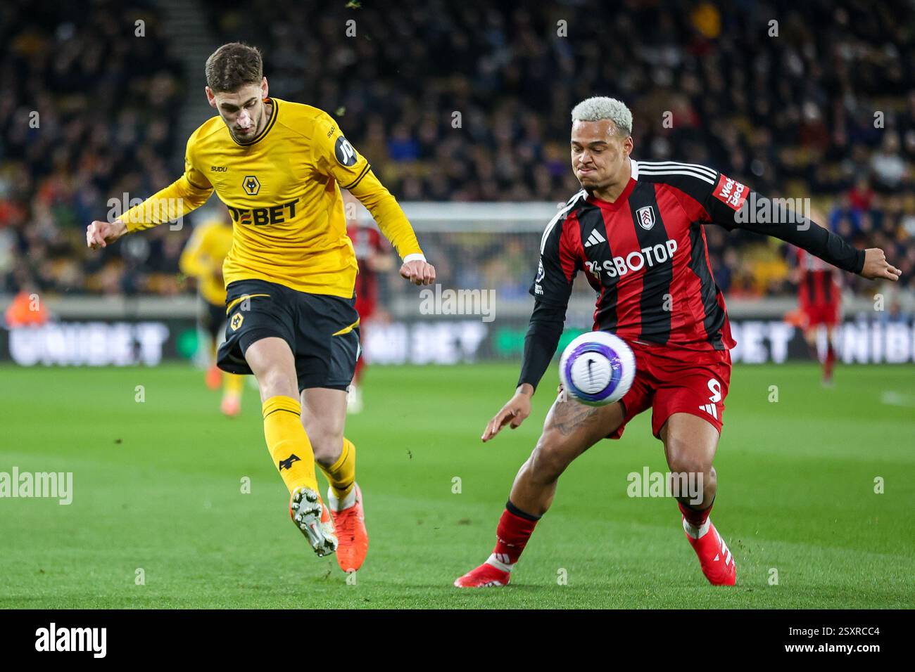 #4, Santiago Bueno of Wolves attempts to get his toe to the ball ahead ...