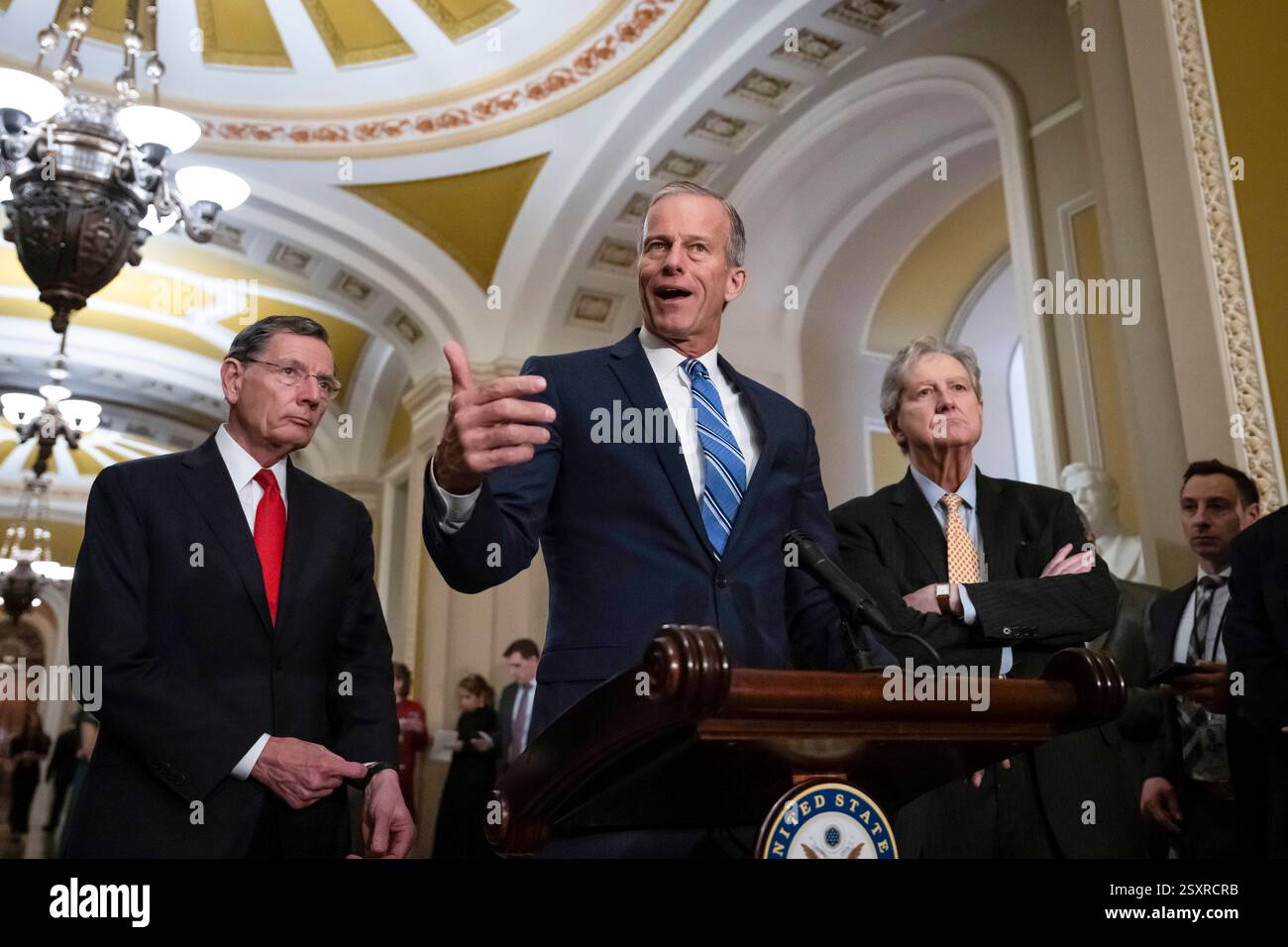 Senate Majority Leader Sen. John Thune, R-S.D., center, accompanied by ...