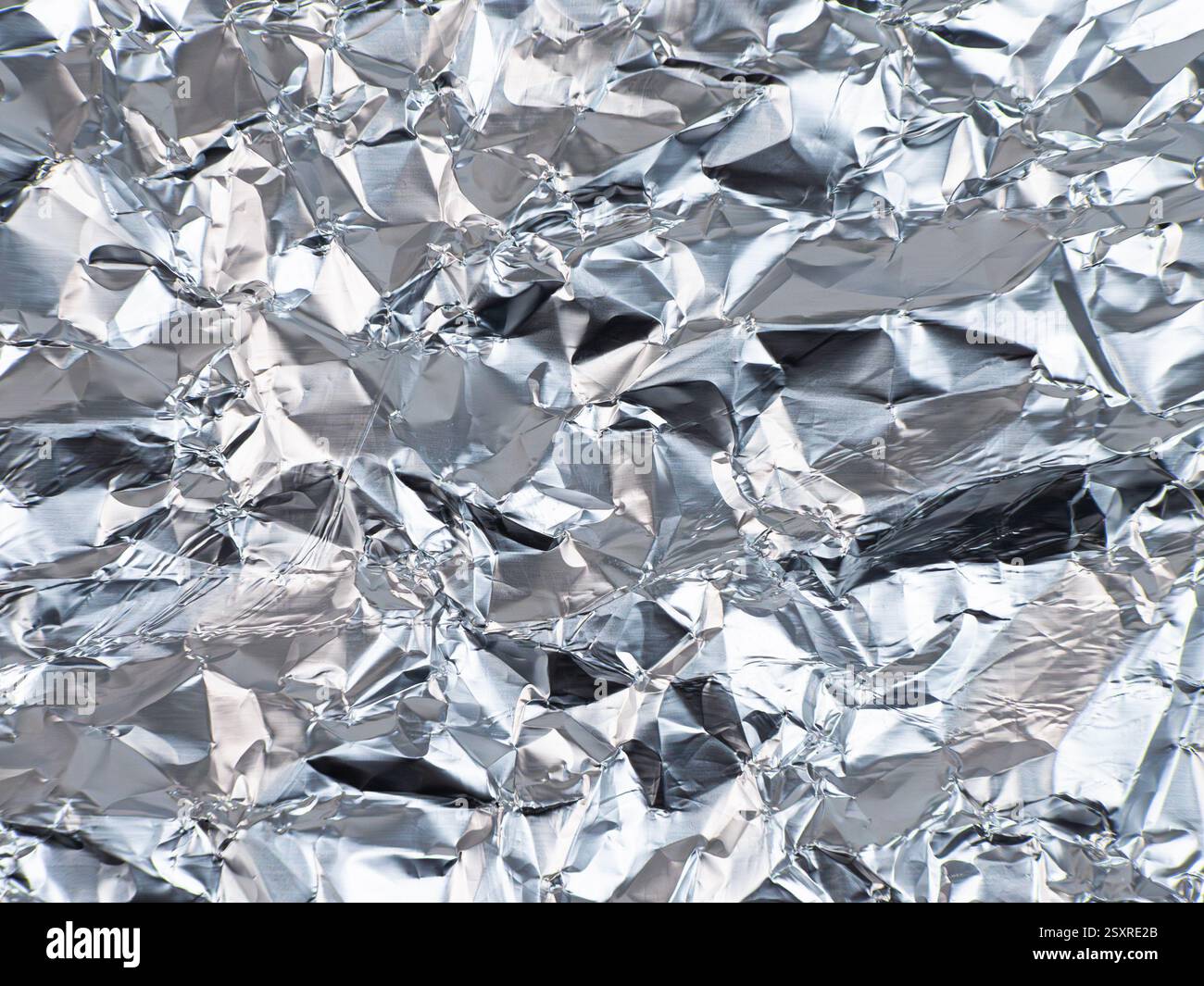 Crinkled foil reflects light and creates a textured surface with shine ...