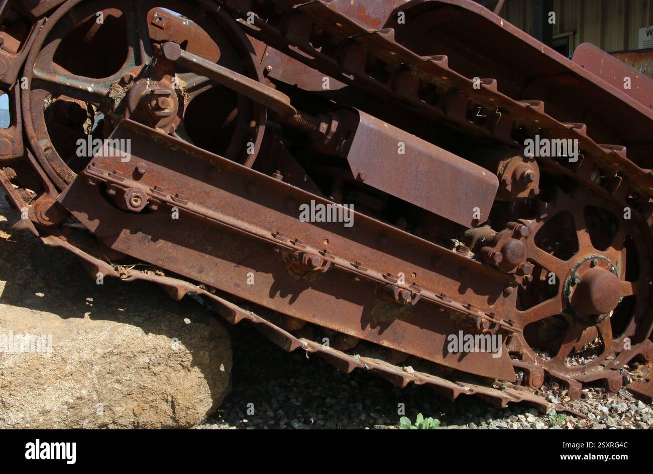 An old tracked piece of heavy construction equipment climbs a large ...
