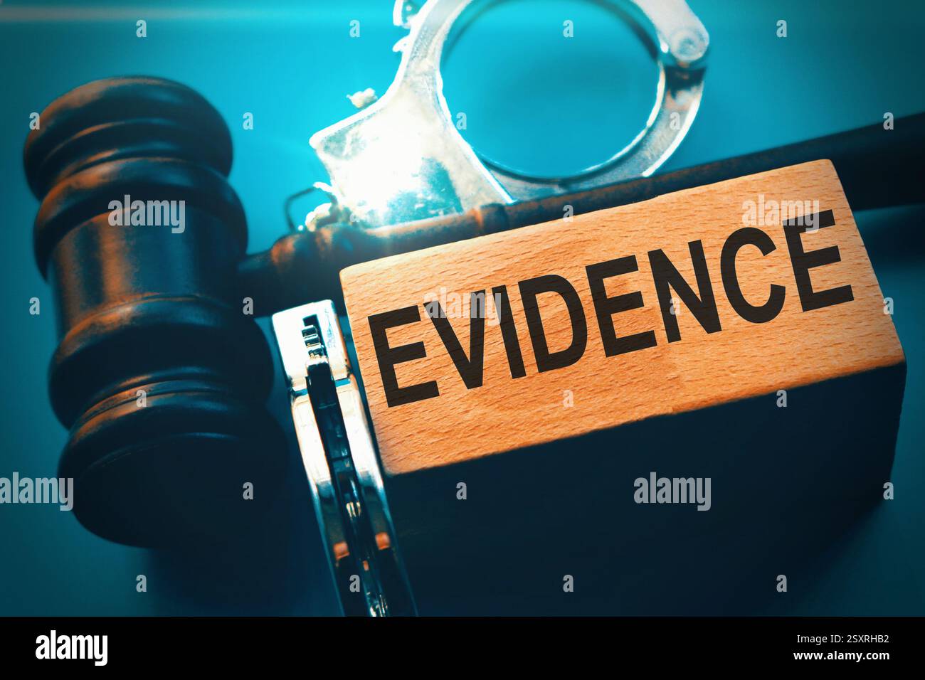 Word EVIDENCE composed of wooden letters with gavel and handcuffs as ...