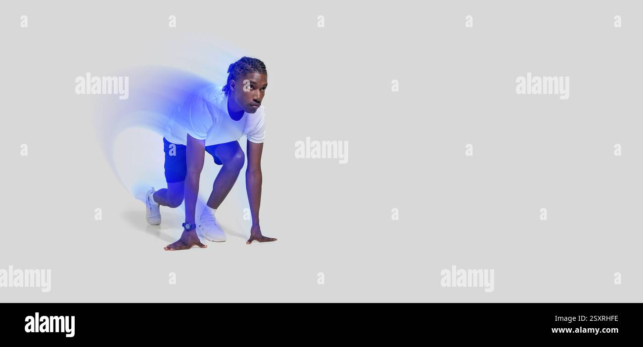 Ready to run man in athletic pose on white background Stock Photo - Alamy