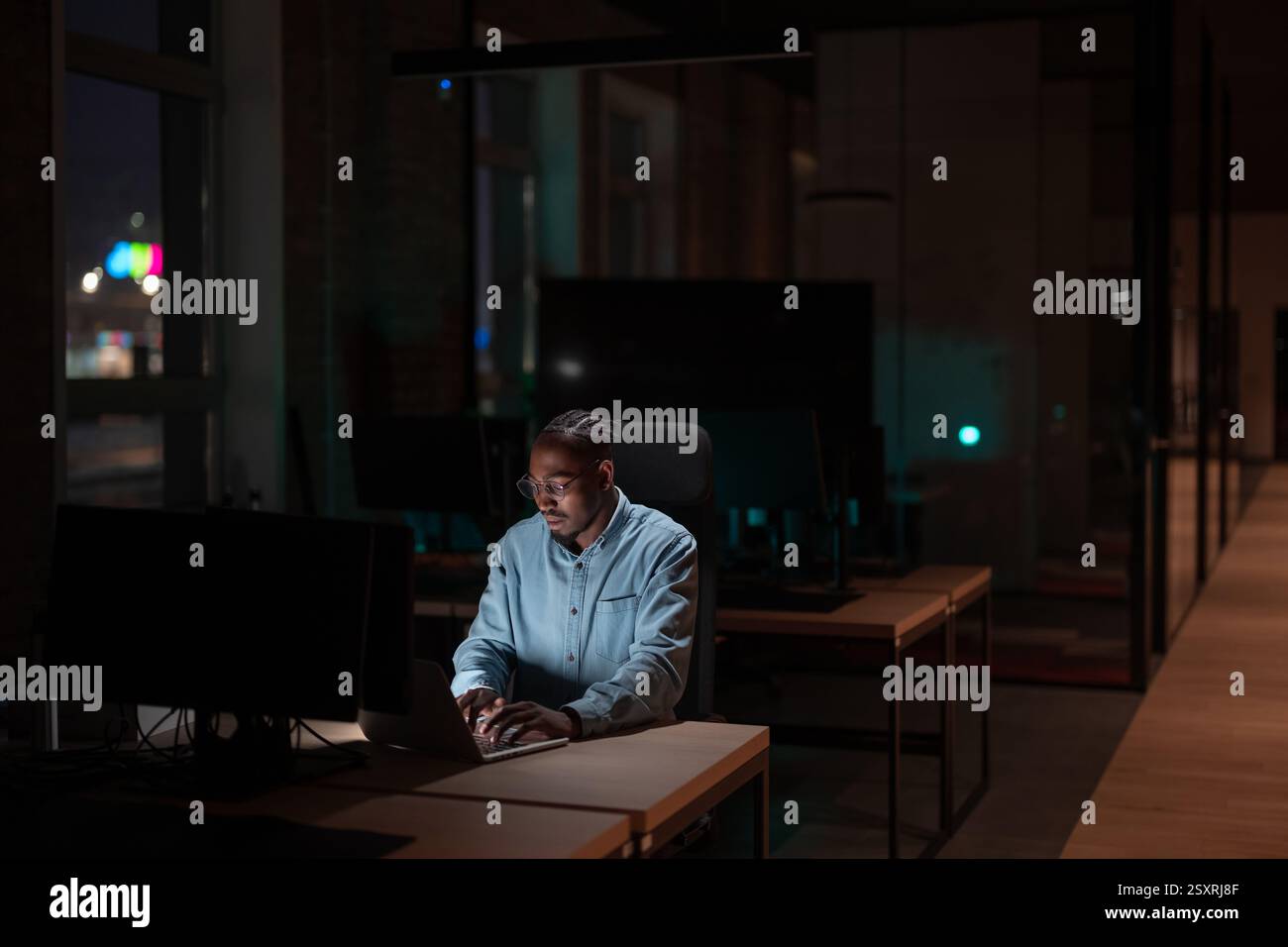 Female businesswoman employee working late in the office, using a ...