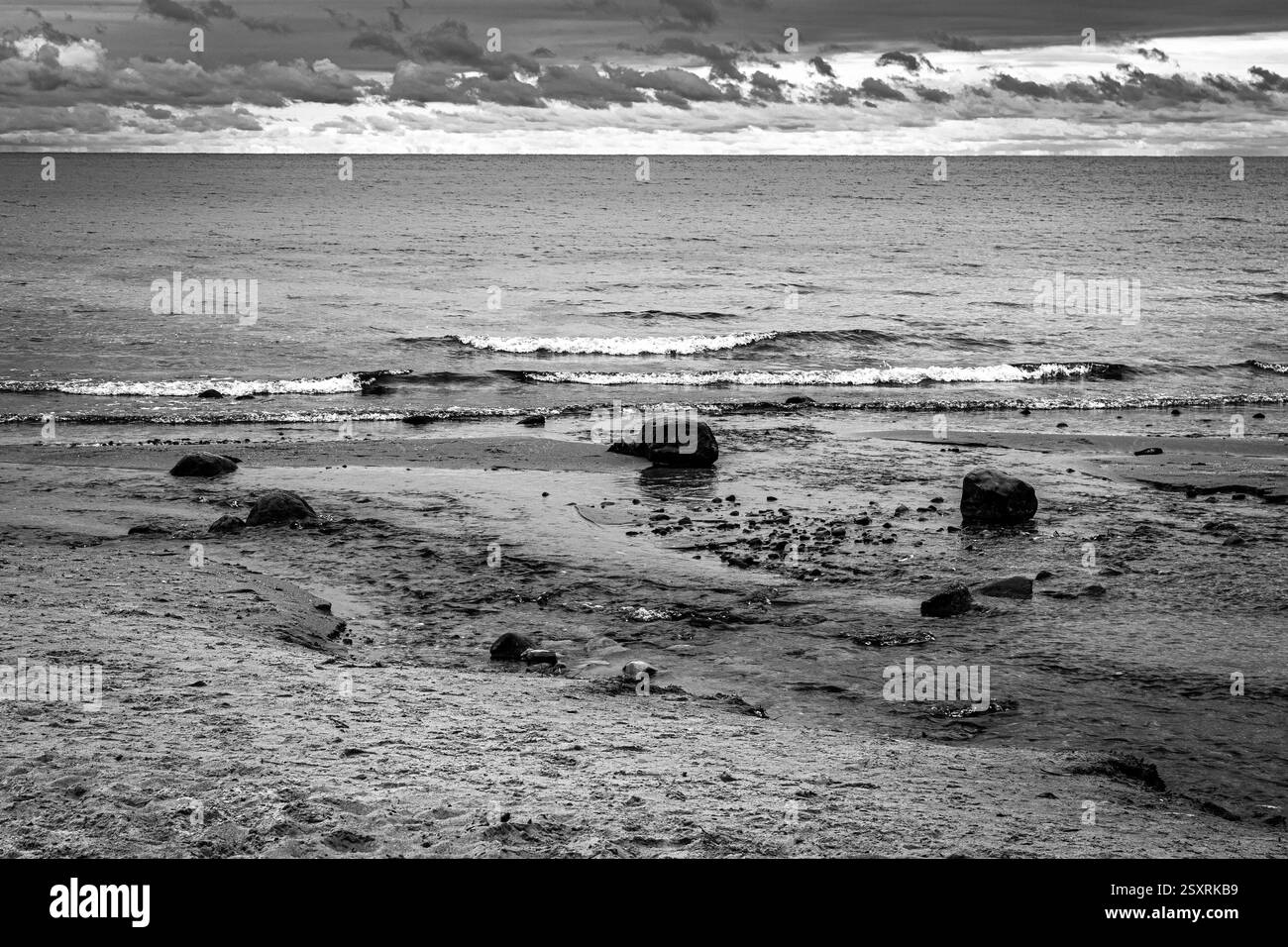 Waves on sandy shore black Black and White Stock Photos & Images - Alamy
