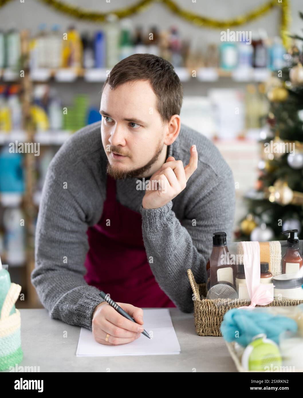 Middle-aged man restocking using paper in store with New Year ...