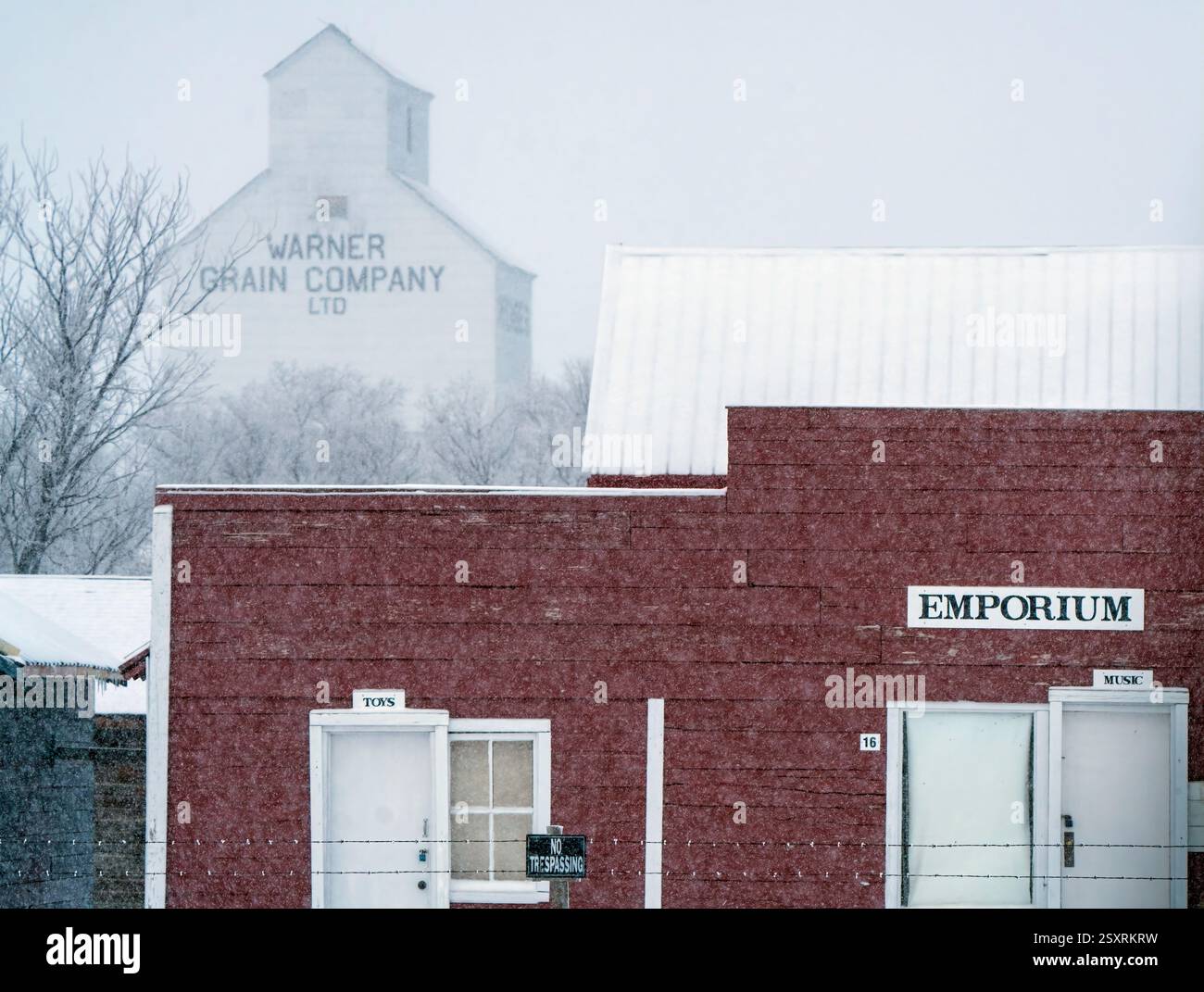 Snow falling on a grain elevator and emporium in a small town Stock ...