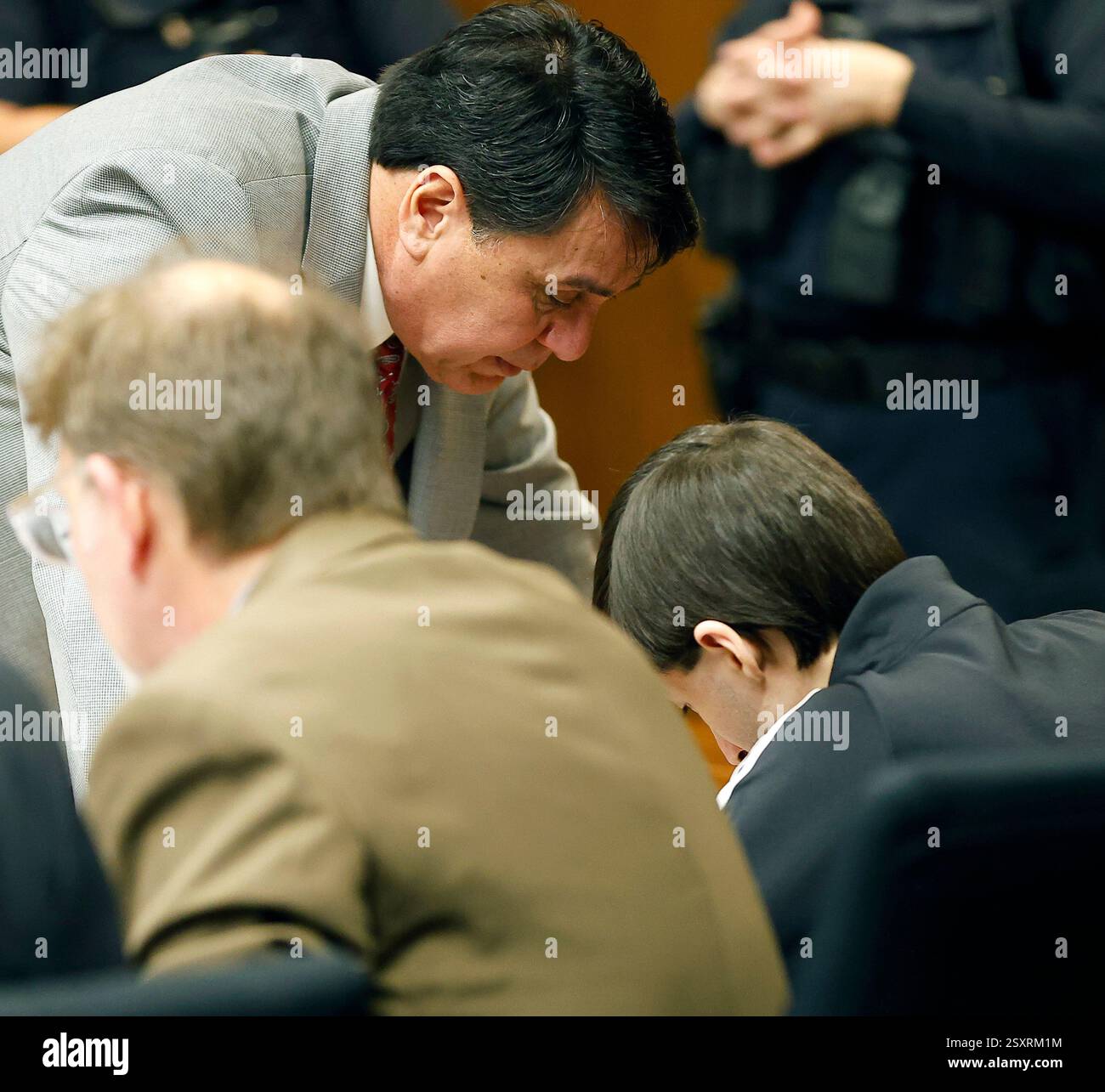 Public defender Gregory Ticsay speaks to his client Robert Crimo III ...