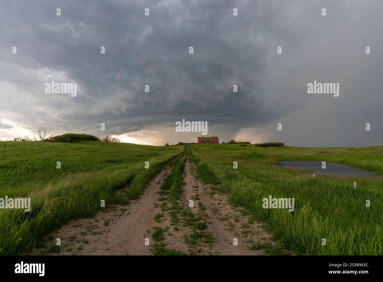 Large supercell thunderstorm is developing over a farmhouse in the ...
