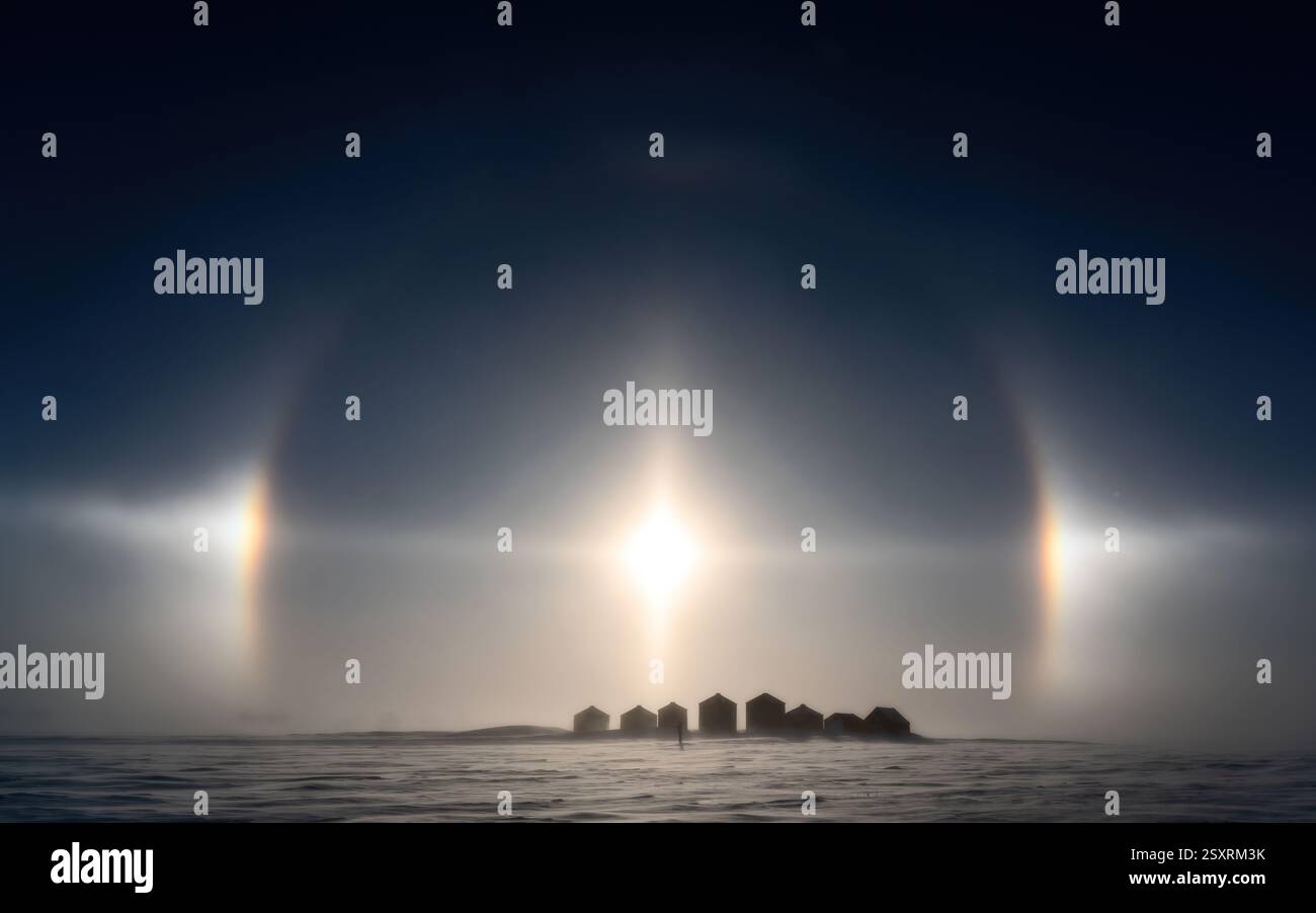 Sun dogs and a halo are creating atmospheric optics over a snowy ...