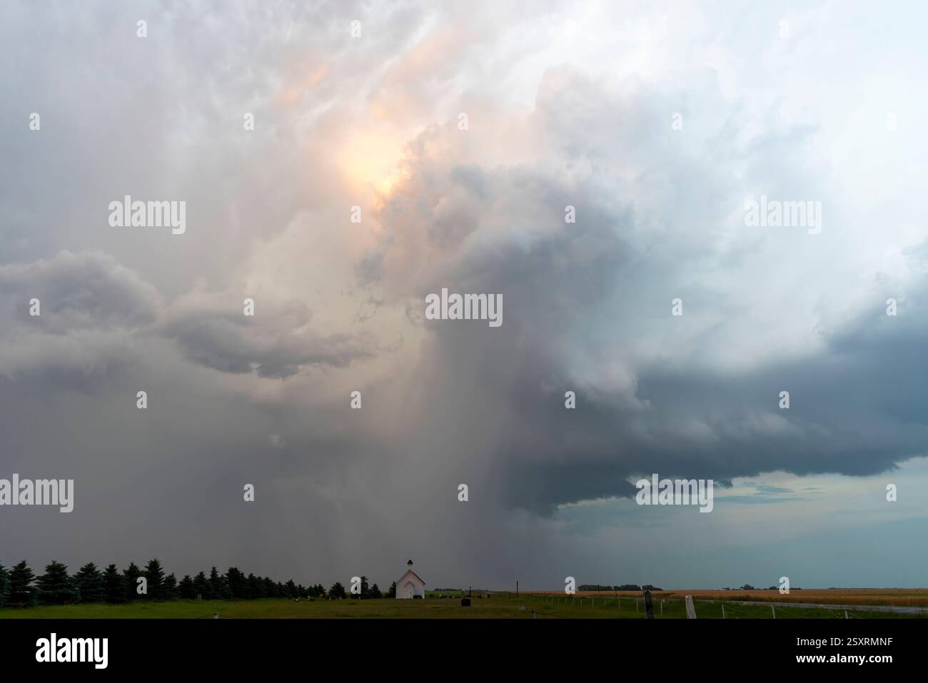 Ominous storm clouds are gathering over a small church in a rural ...