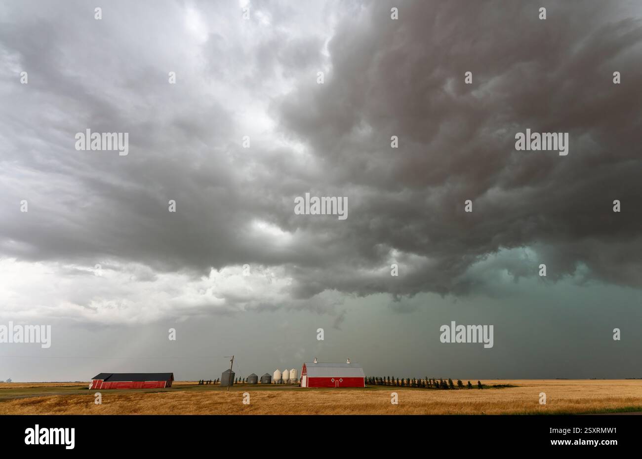Looming supercell thunderstorm clouds creating a dramatic sky over a ...