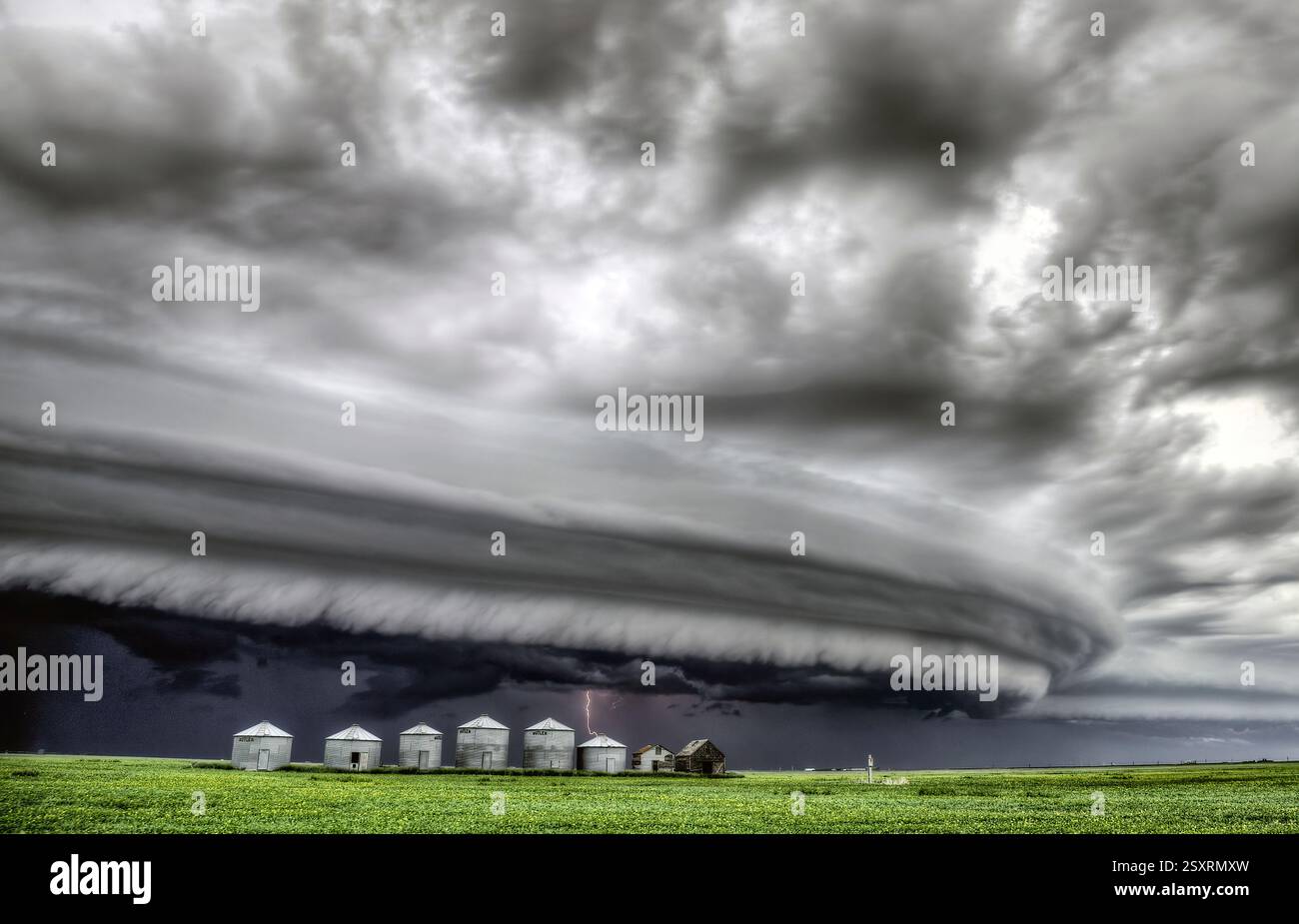 Dramatic storm clouds forming a shelf cloud over a farm in saskatchewan ...