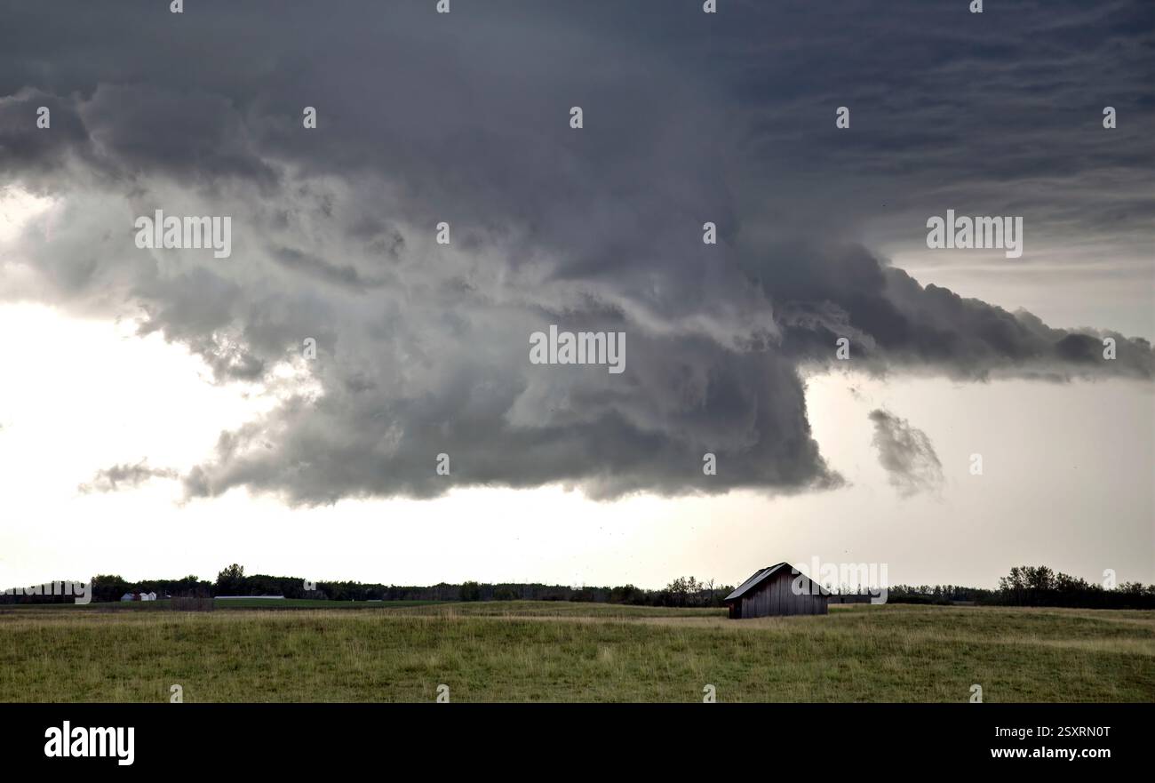 Dark supercell storm clouds gathering over a lonely barn in the ...
