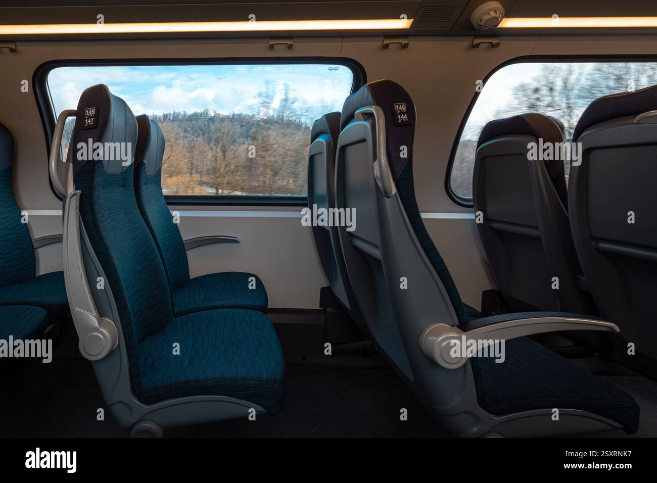 side view of seats and windows in a modern double decker train with ...