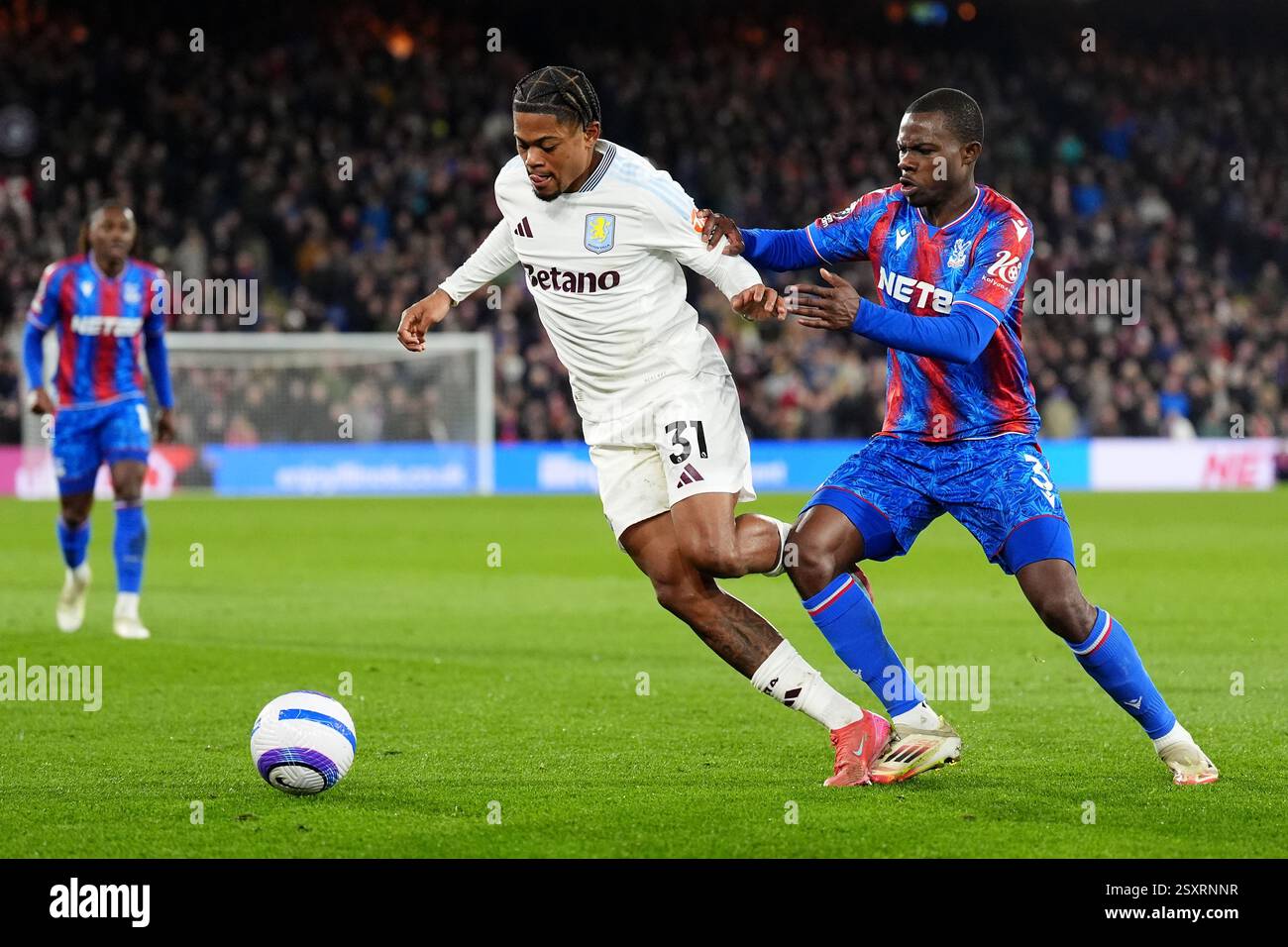Aston Villa's Leon Bailey (left) and Crystal Palace's Tyrick Mitchell ...