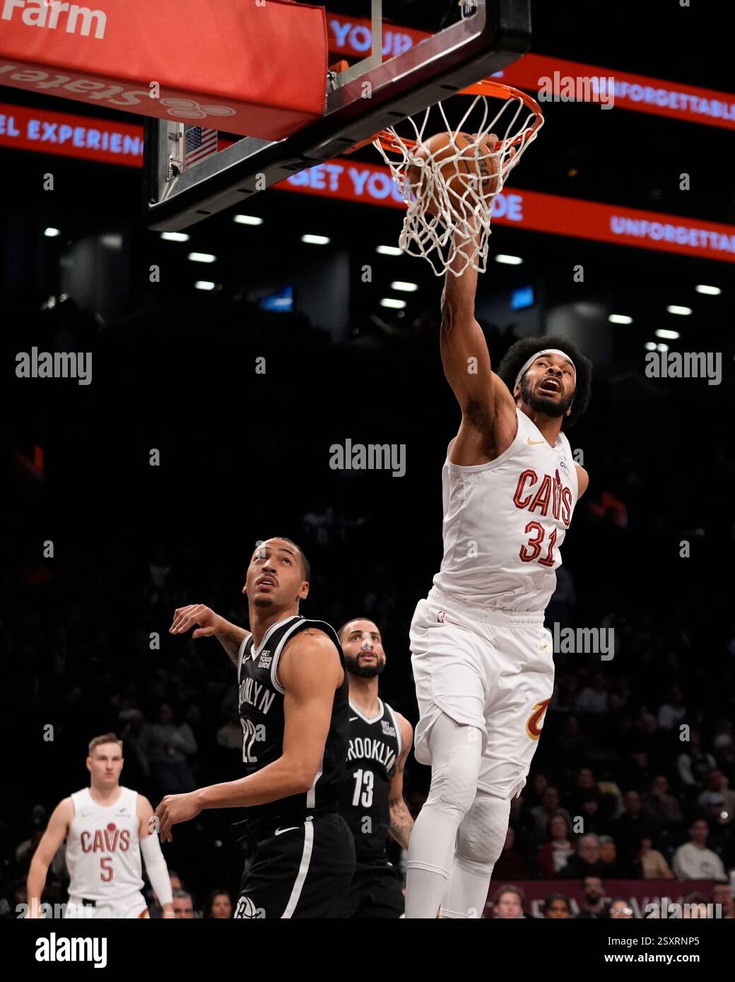 Cleveland Cavaliers' Jarrett Allen (31) dunks the ball in front of ...