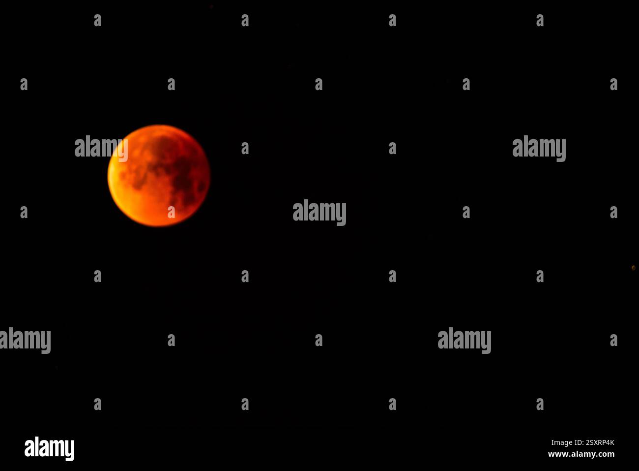 A glowing blood moon during a partial lunar eclipse at night Stock ...