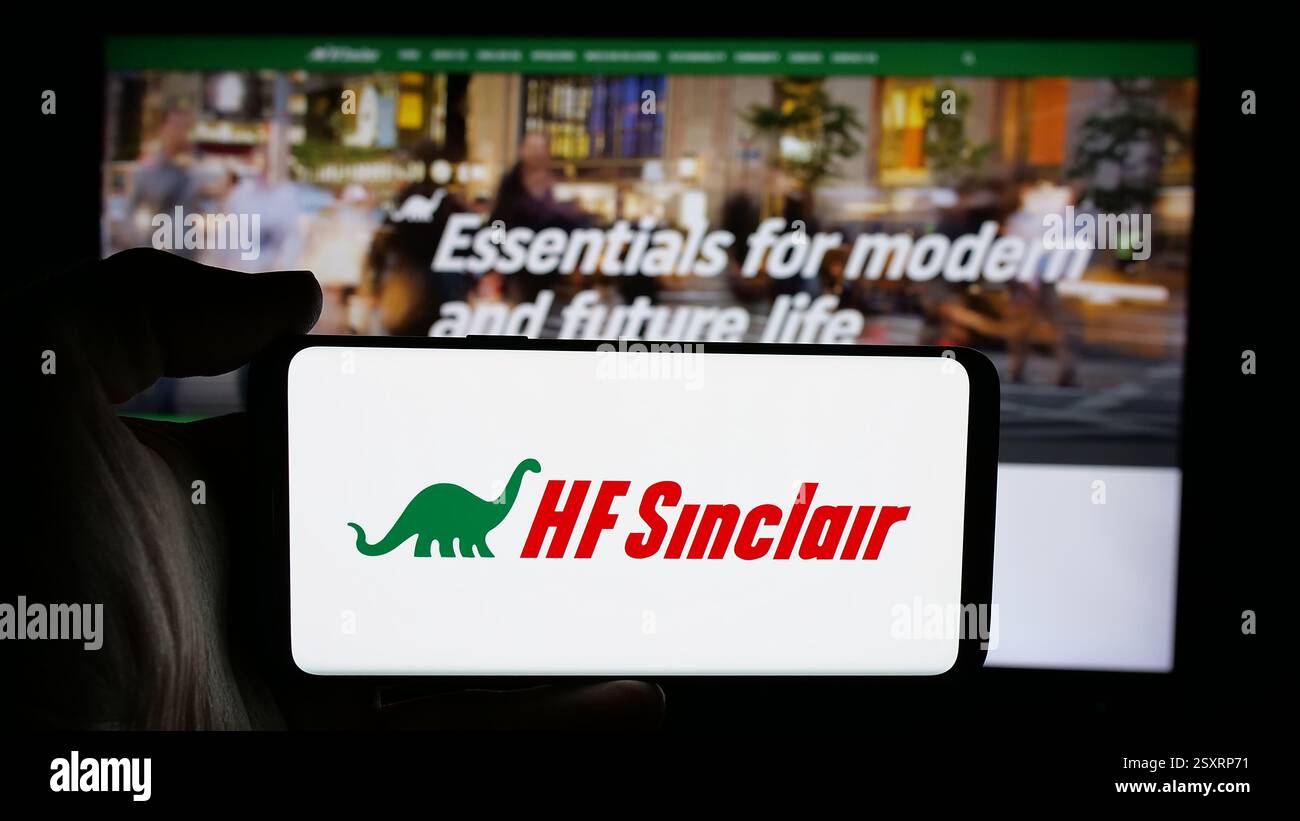 November 26, 2024, Germany: In this photo illustration, a person is holding a cellphone with the ...