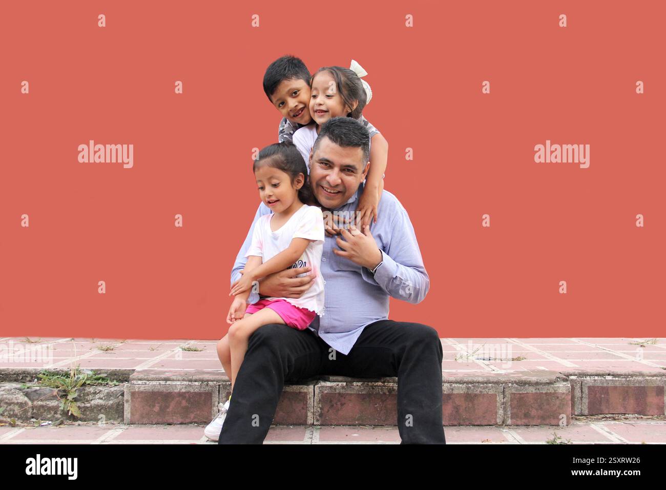 Latin family of a single dad with his 2 daughters and a son are happy ...