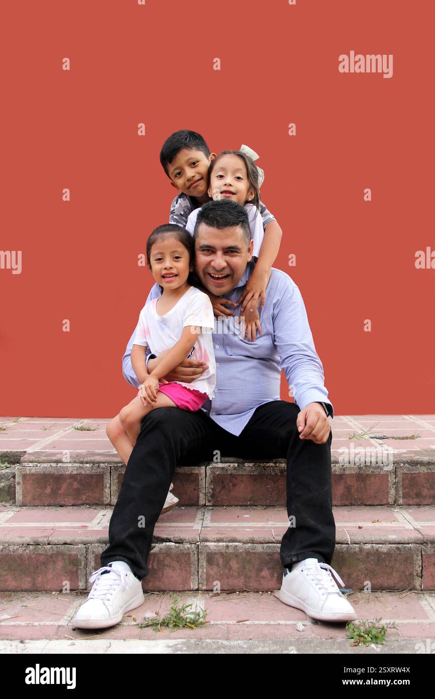 Latin family of a single dad with his 2 daughters and a son are happy ...