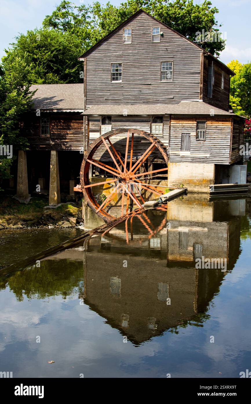 Large, old-fashioned building with a water wheel on the front. The ...