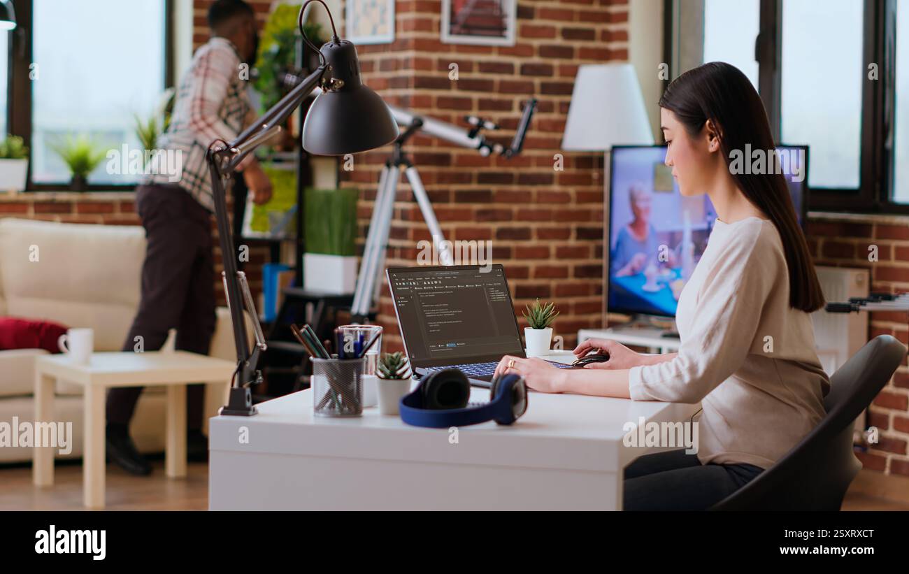 Software developer types programming code in a cozy home office setup ...
