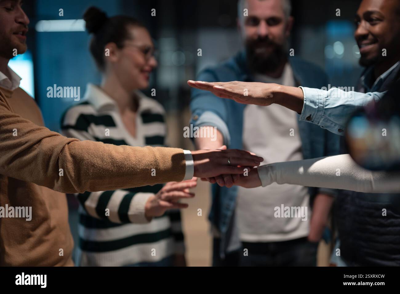 Business professionals stacking hands in support of collaboration ...