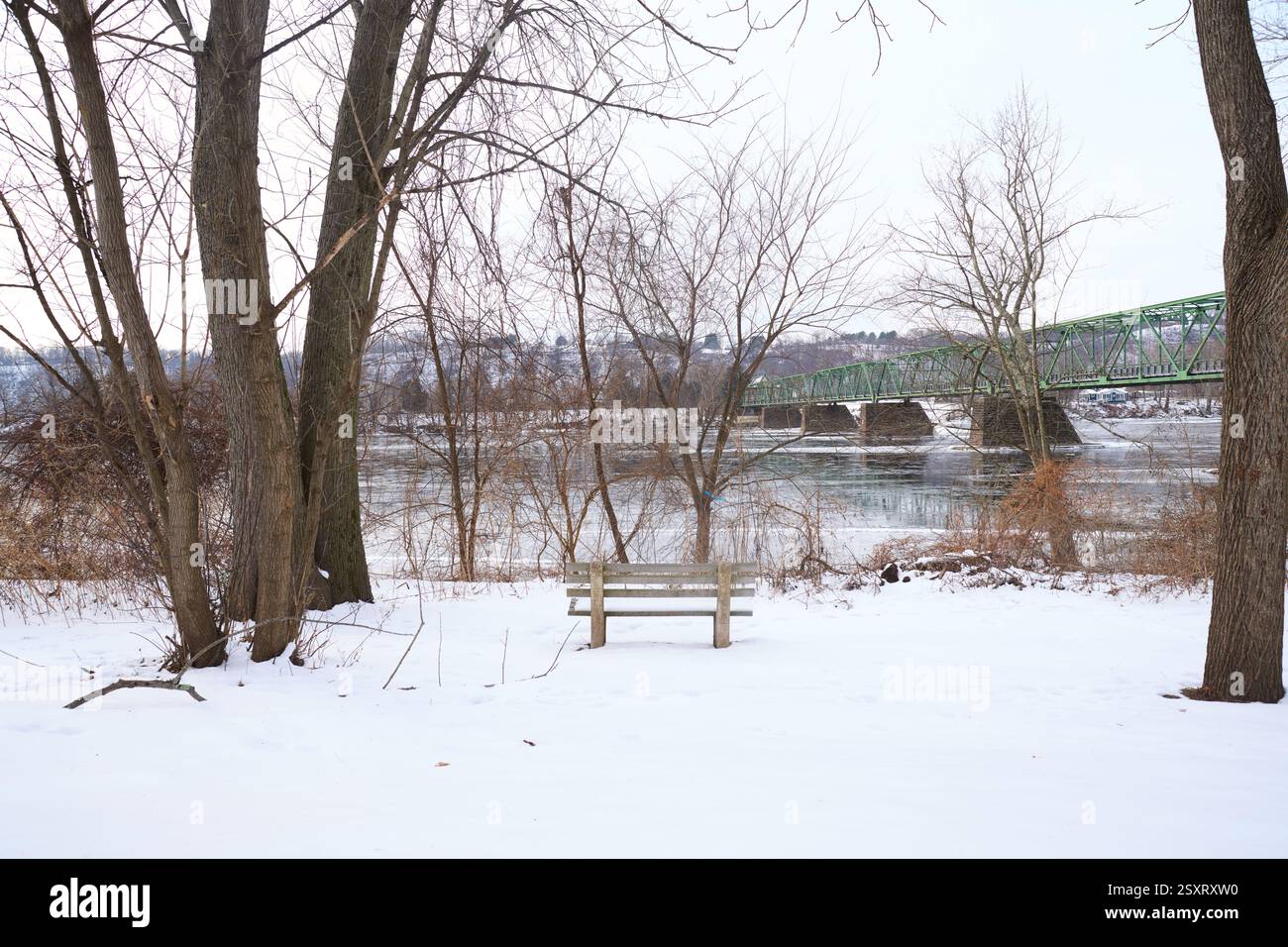 A bench on a snowy field overlooking the Delaware River Stock Photo - Alamy