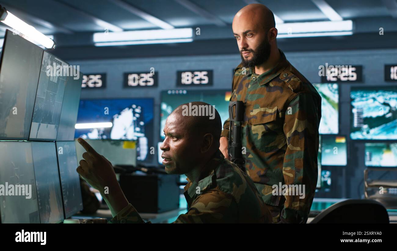 Military officers looking at tracking equipment screens to gain info ...